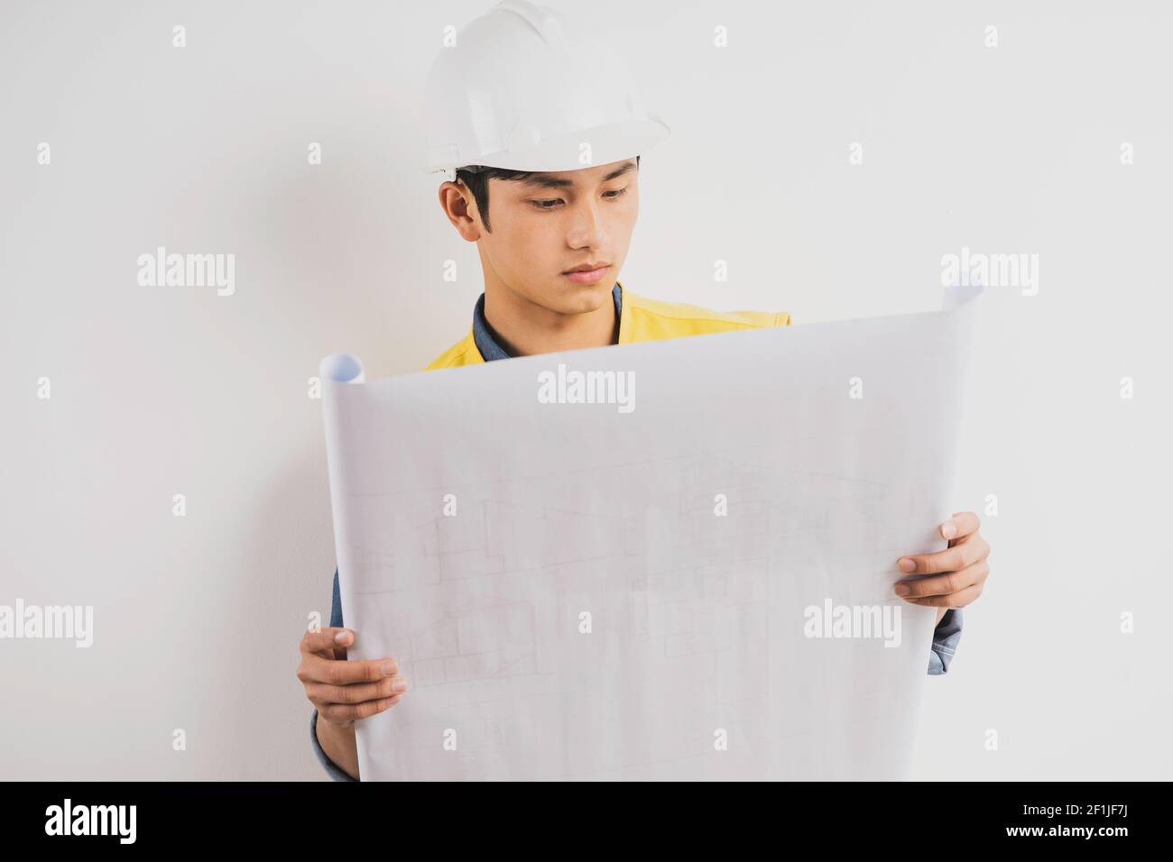 Asian construction engineer reading the technical drawing Stock Photo ...