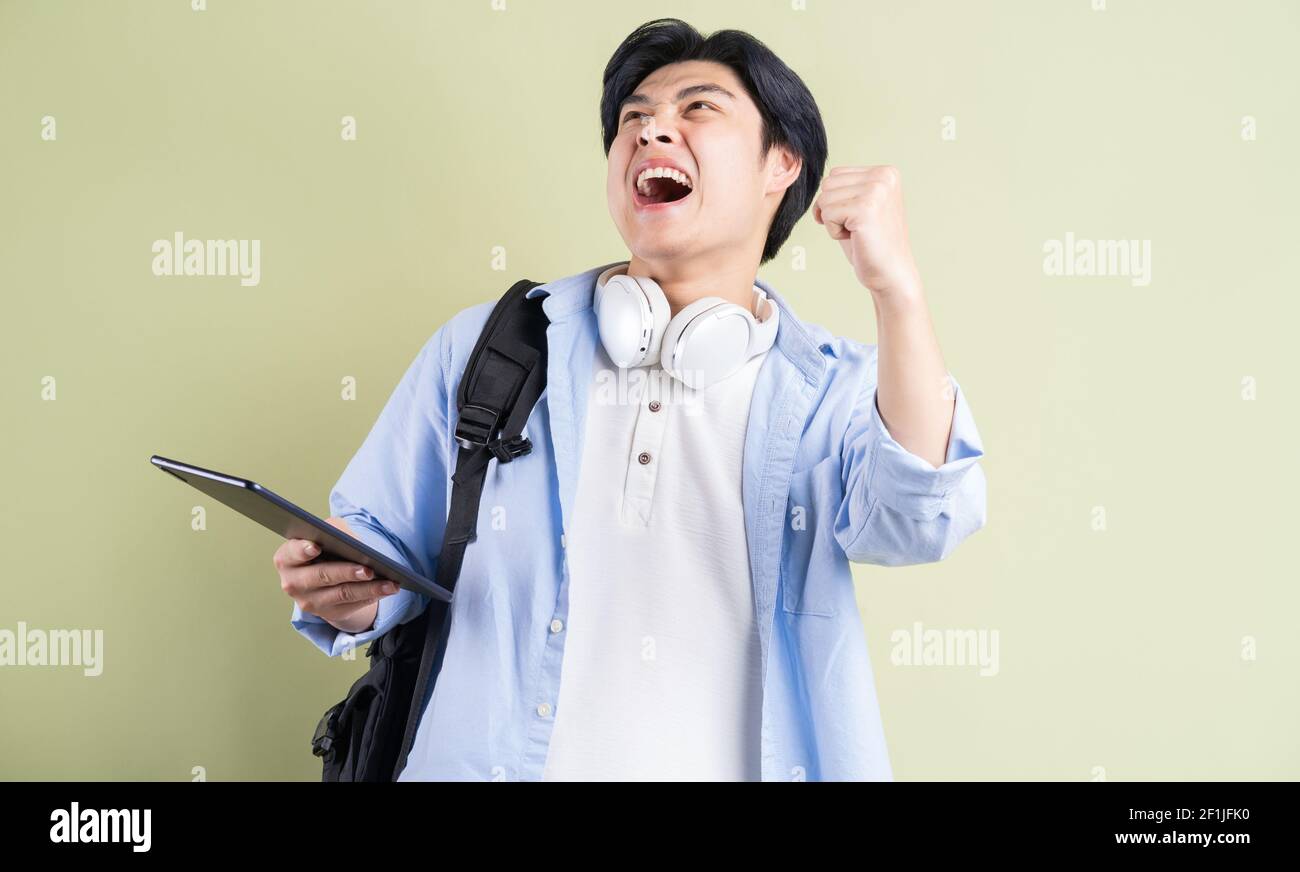 Male Asian students were shouting out of victory feelings Stock Photo ...