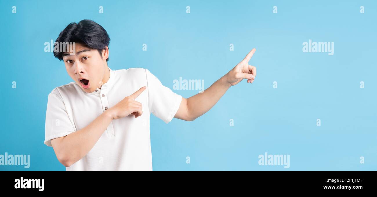 The Asian man was pointing his hand to the left Stock Photo - Alamy