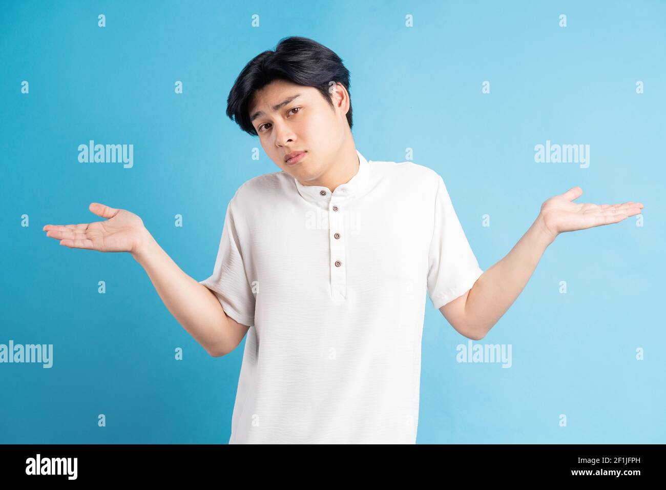 The Asian man was shrugging his shoulders with a puzzled expression ...