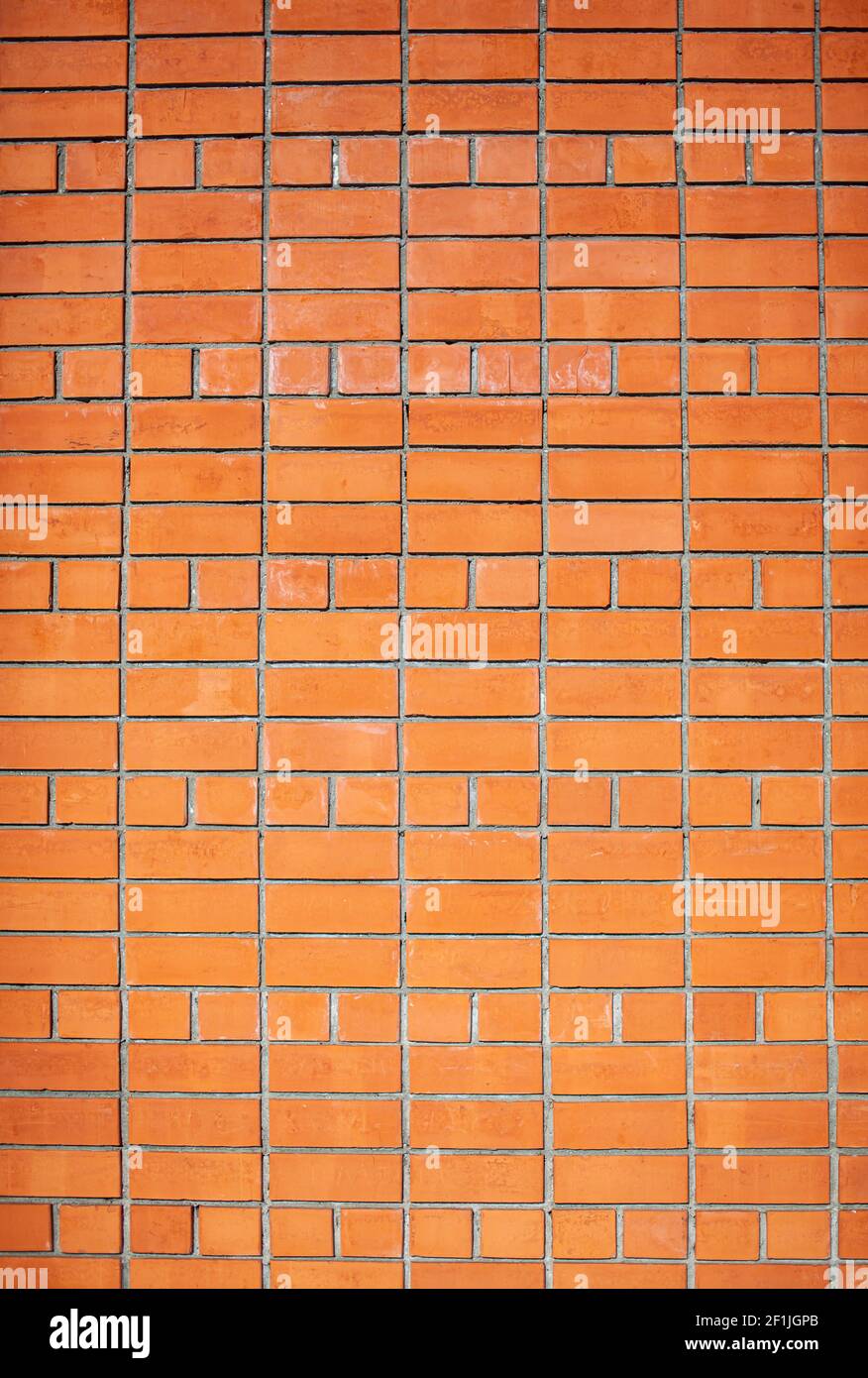A new, smooth red brick wall. The bricks are laid in rows. Grunge stone ...