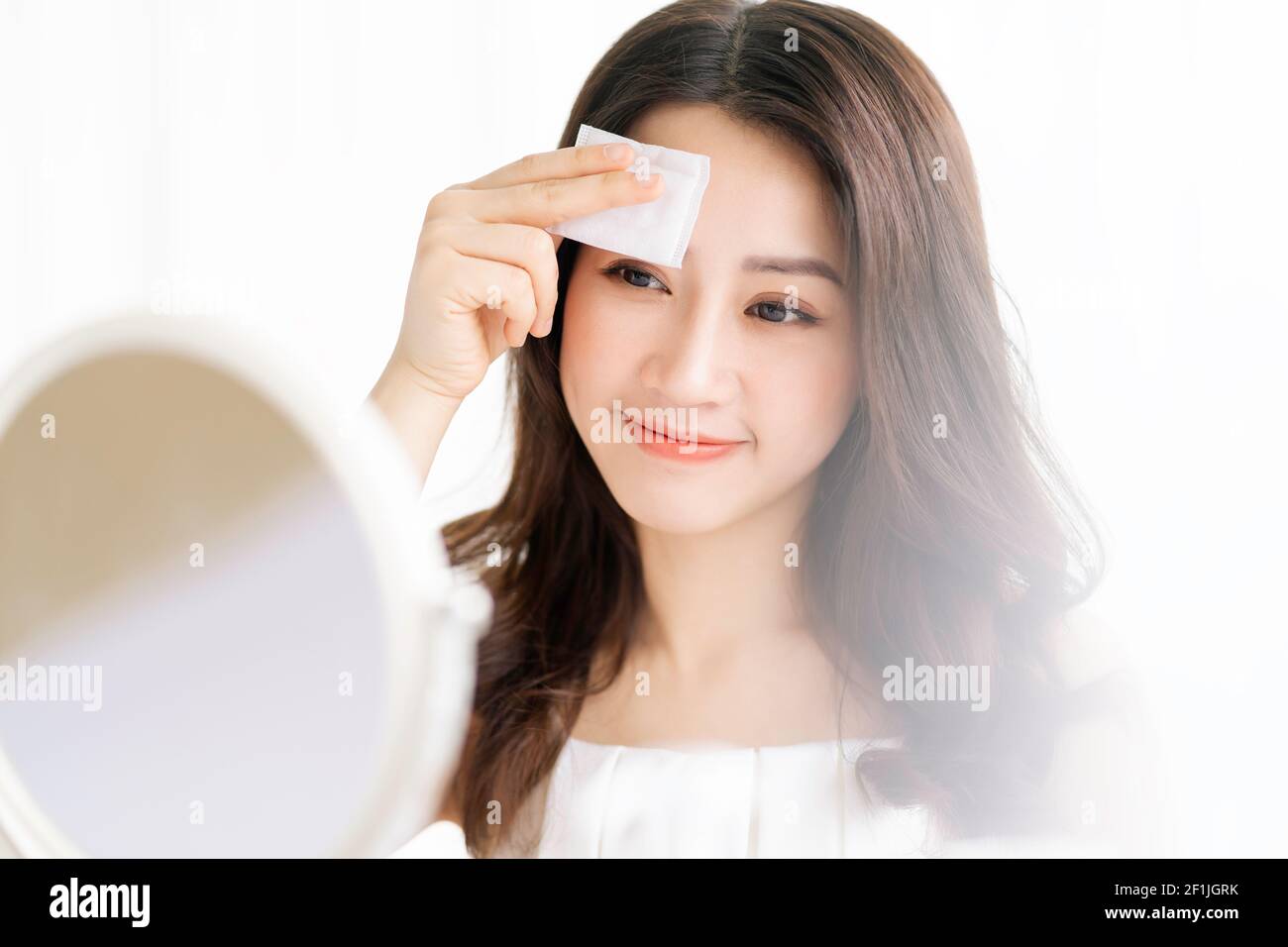 Asian woman sitting makeup in front of mirror Stock Photo - Alamy