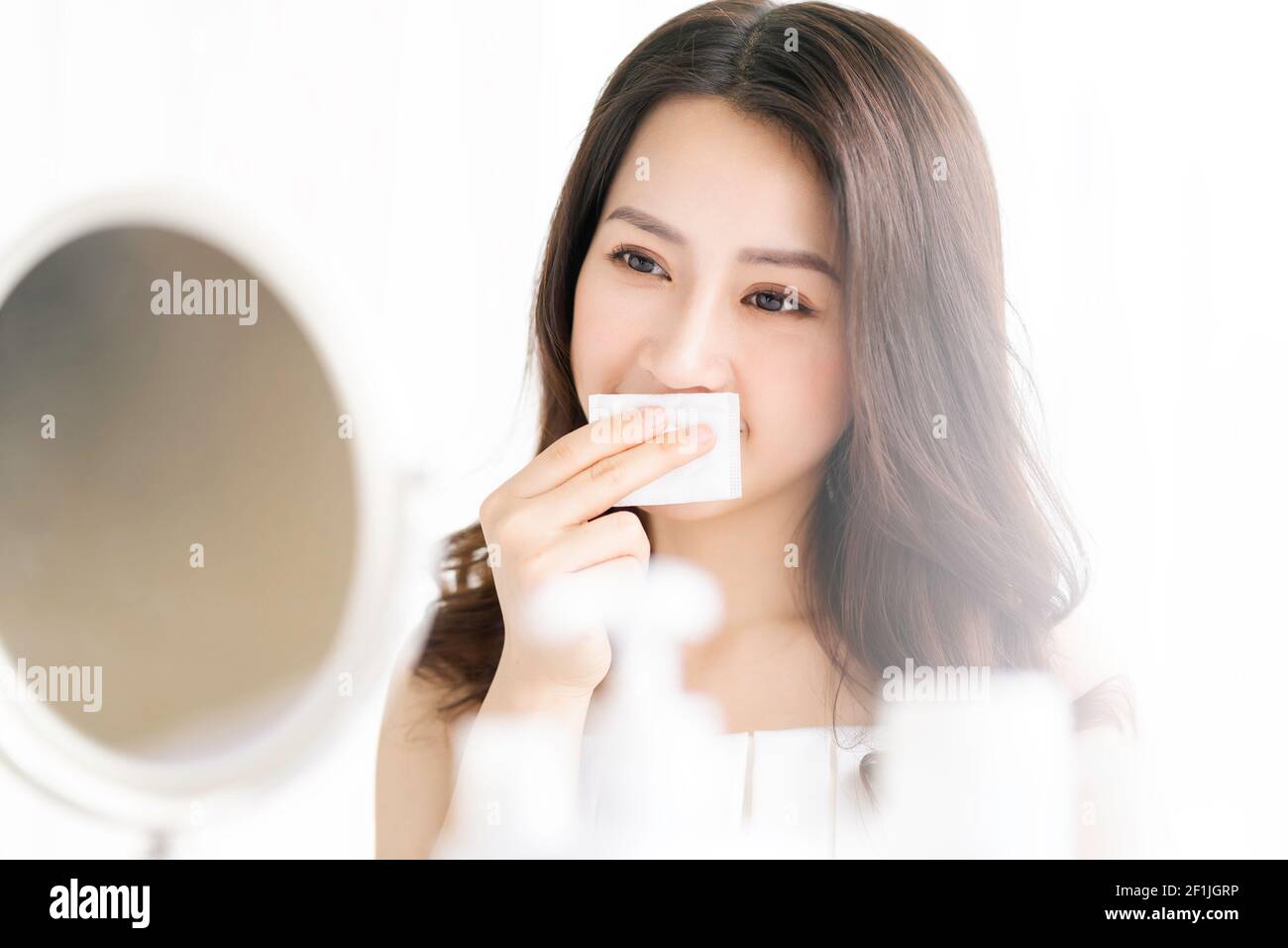 Asian woman sitting makeup in front of mirror Stock Photo - Alamy