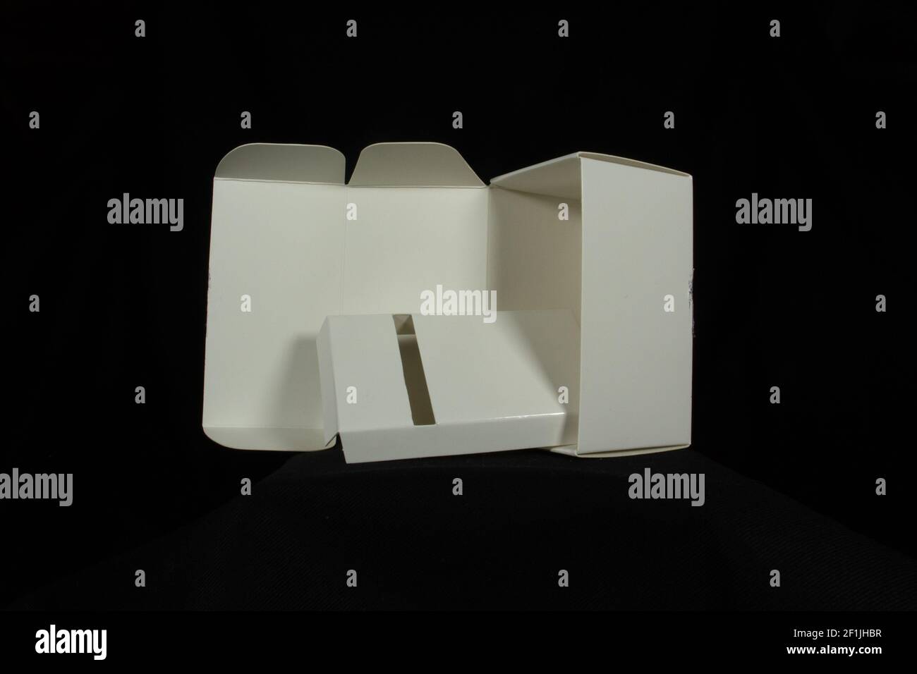 open white box with closing tabs and with insert in shadow isolated on ...