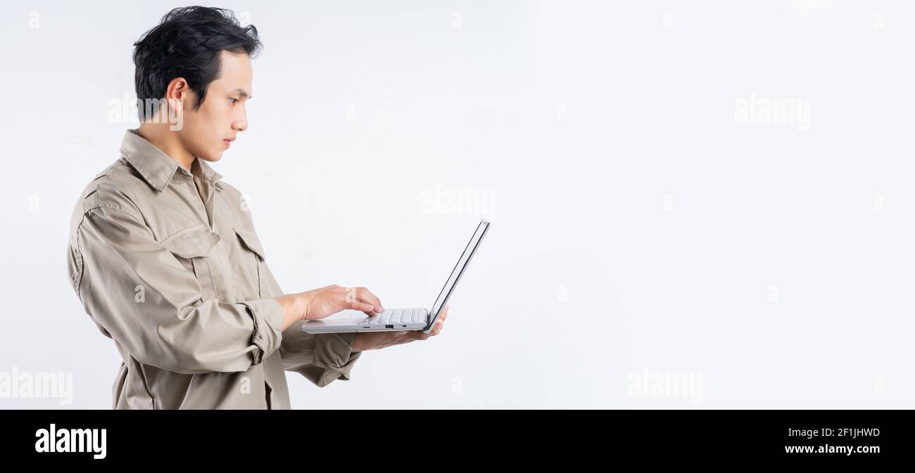 Male fabrication engineer standing typing on a white background Stock ...