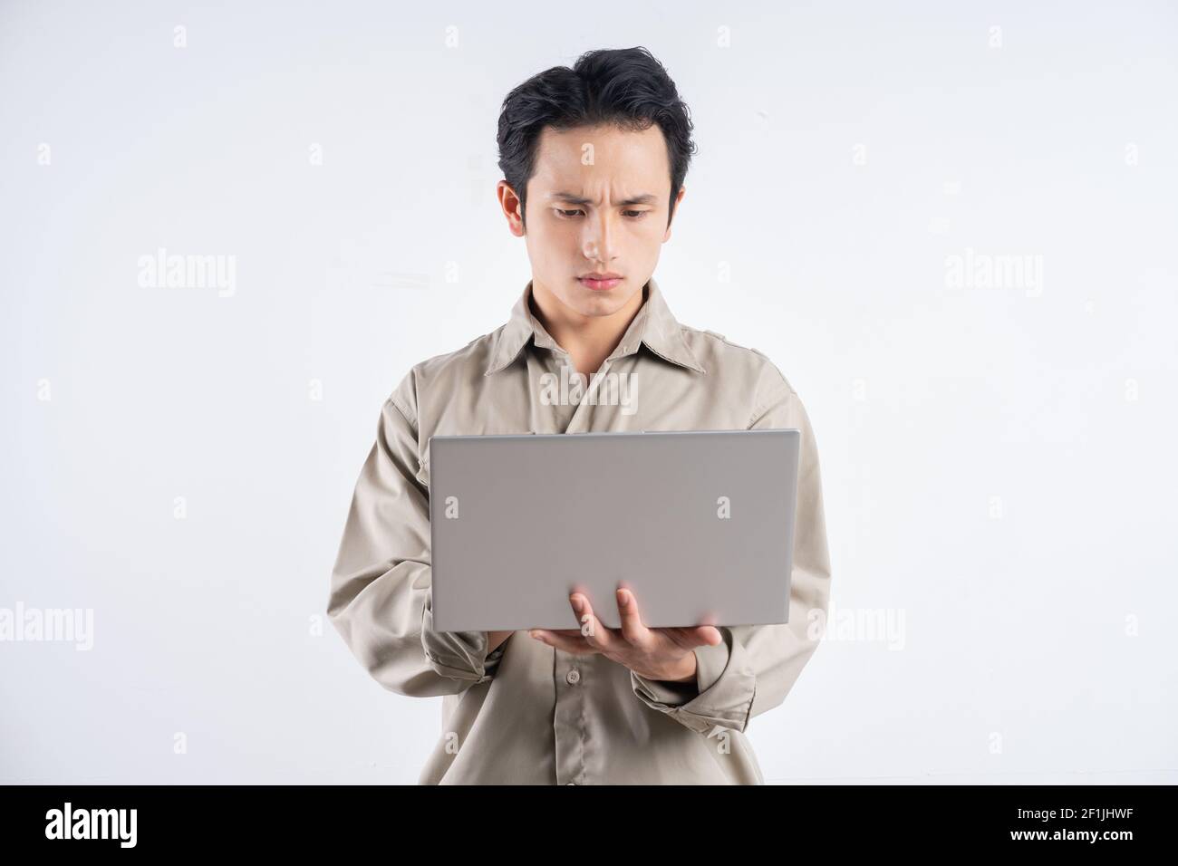 Male fabrication engineer standing typing on a white background Stock ...