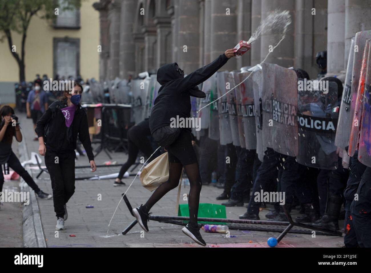 A women confront a police line during the riots caused for the protests ...
