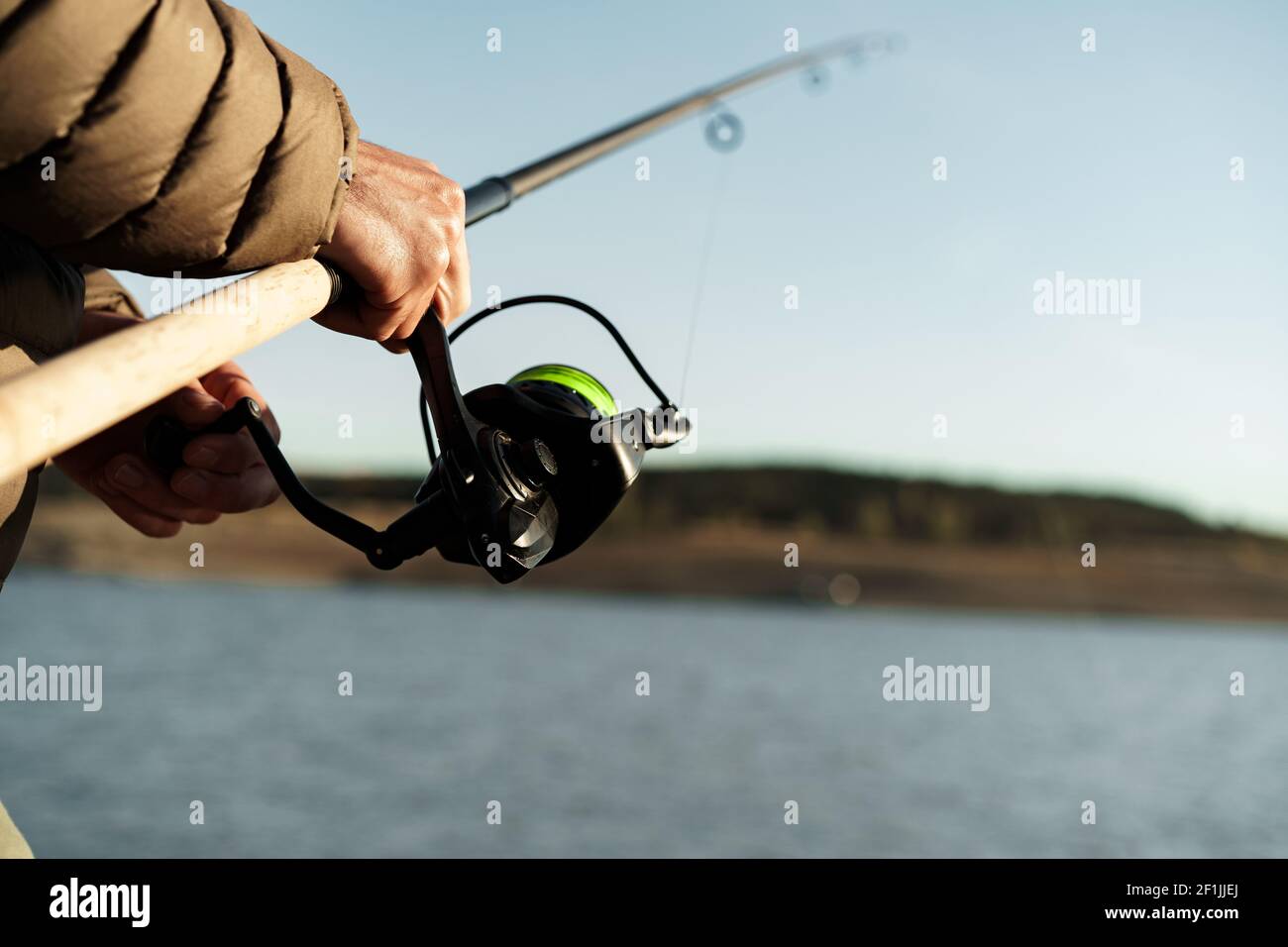 Fisherman hands holding fishing rod close up Stock Photo - Alamy