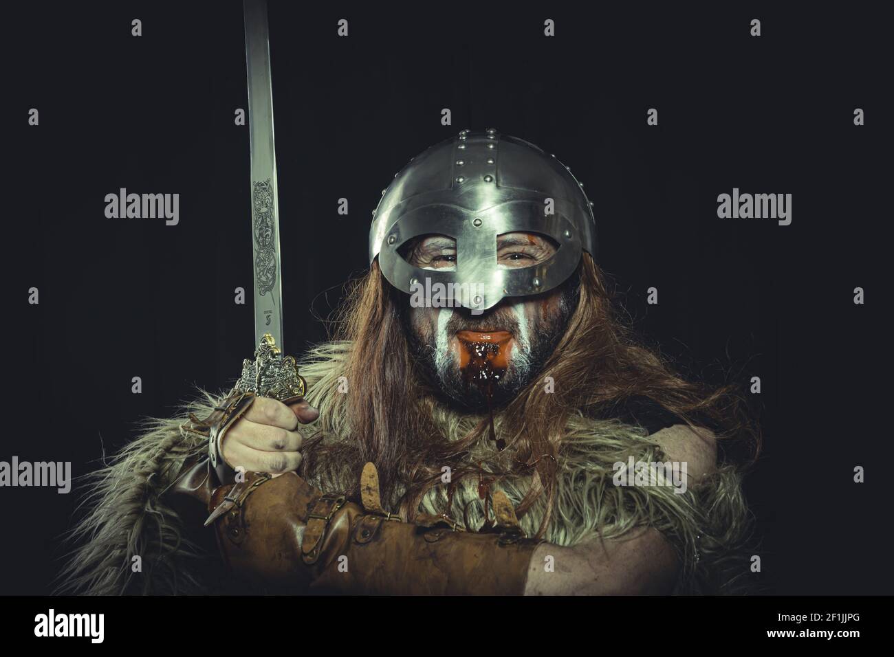 Viking, Scandinavian warrior with helmet and war paintings, wears a ...