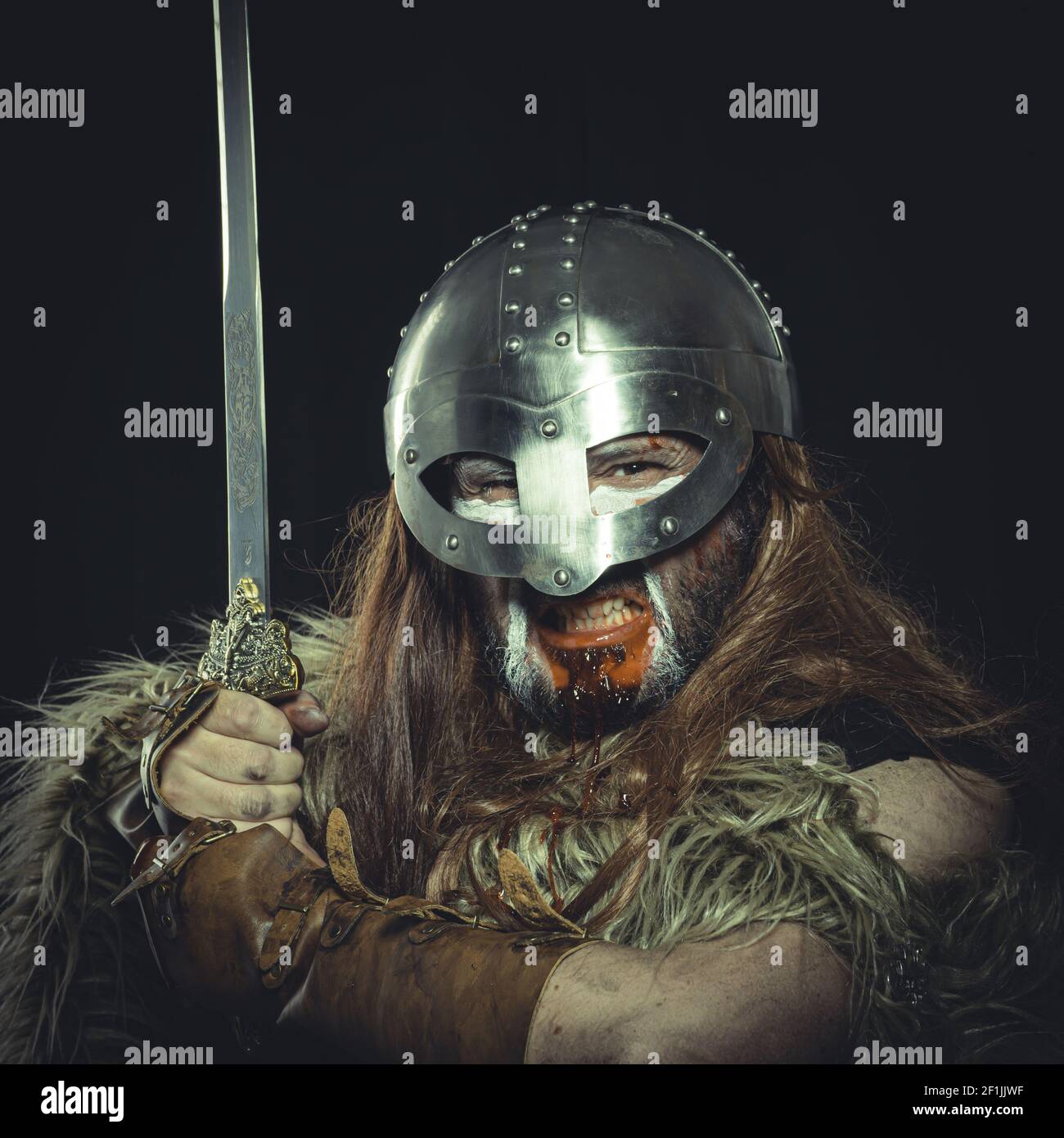 Viking, Scandinavian warrior with helmet and war paintings, wears a ...