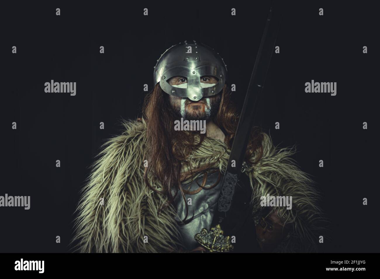 Viking, Scandinavian warrior with helmet and war paintings, wears a ...