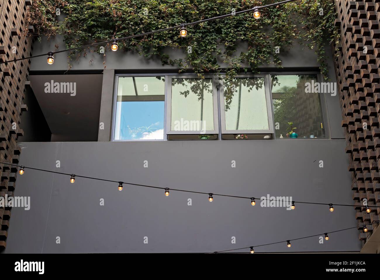 Outside of an apartment between two buildings strung with exterior ...