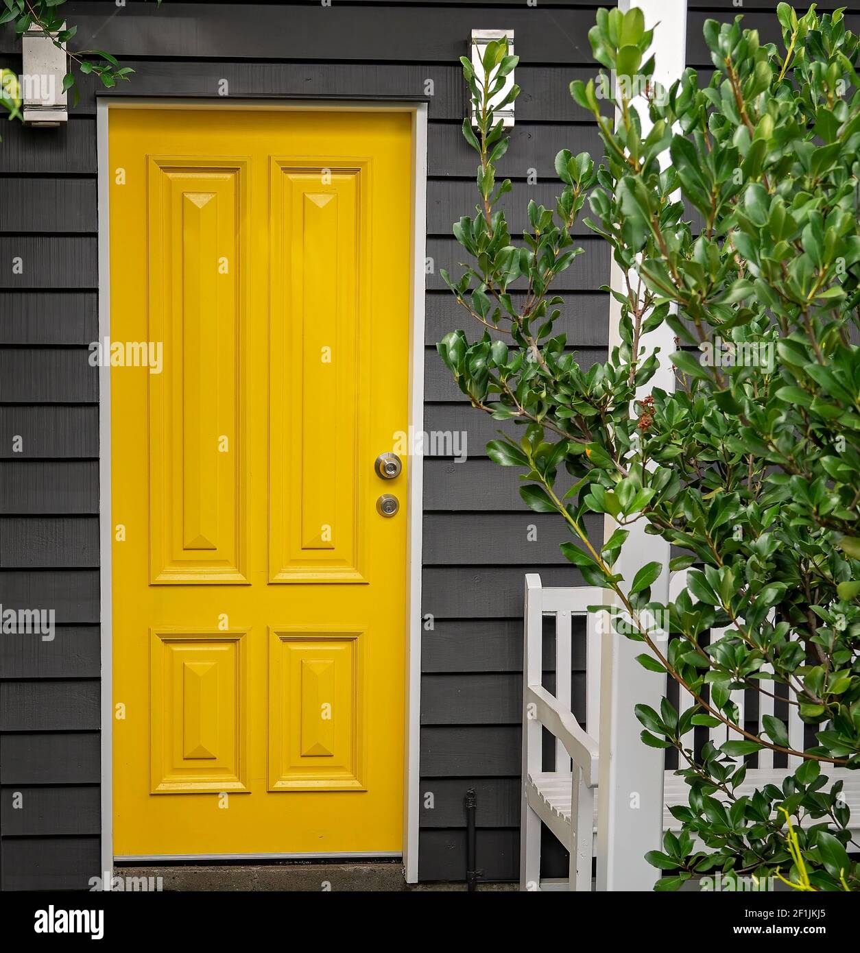 A bright yellow front entrance door in a renovated old Queensland home ...