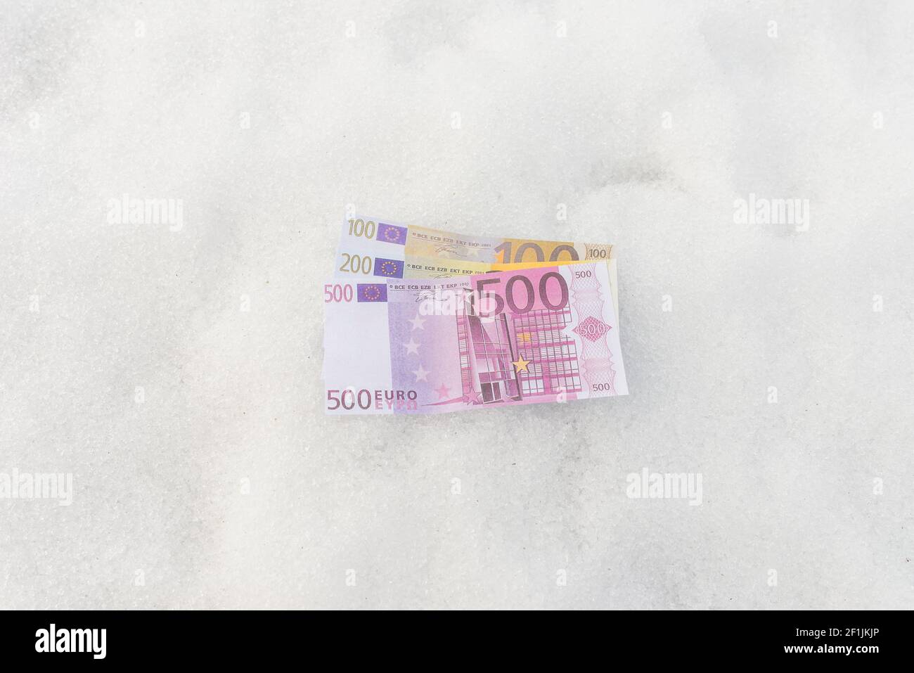 100, 200 and 500 euro money banknotes on white snow background.Money ...