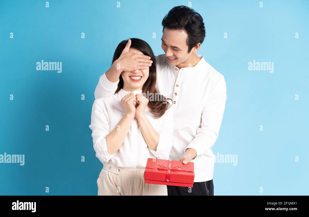 Asian boyfriend gives gifts to his girlfriend on Valentine's Day Stock ...