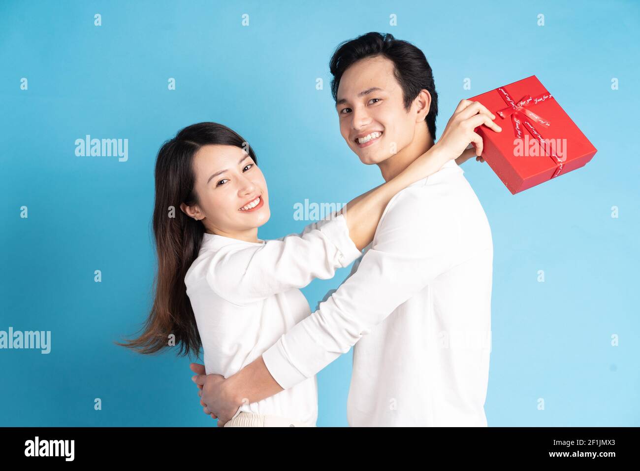 Asian boyfriend gives gifts to his girlfriend on Valentine's Day Stock ...