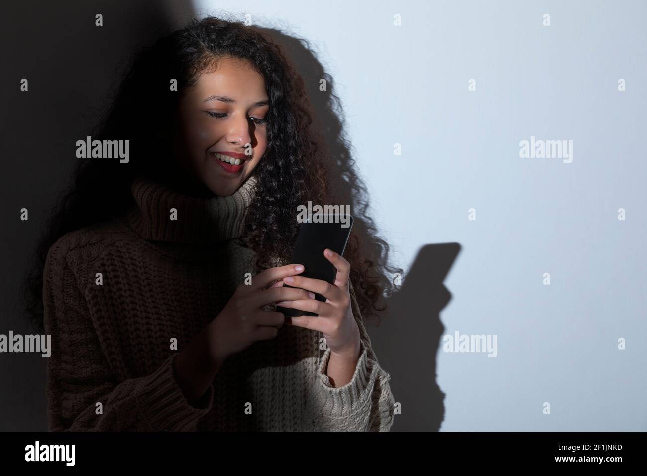 A TEENAGE GIRL HAPPILY USING MOBILE PHONE Stock Photo - Alamy