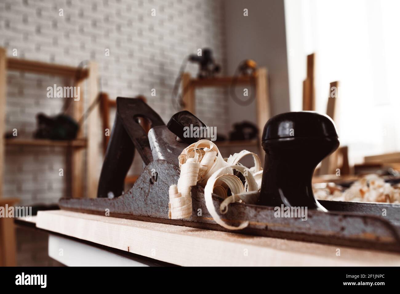 Carpentry plane tool for woodworking in workshop Stock Photo - Alamy