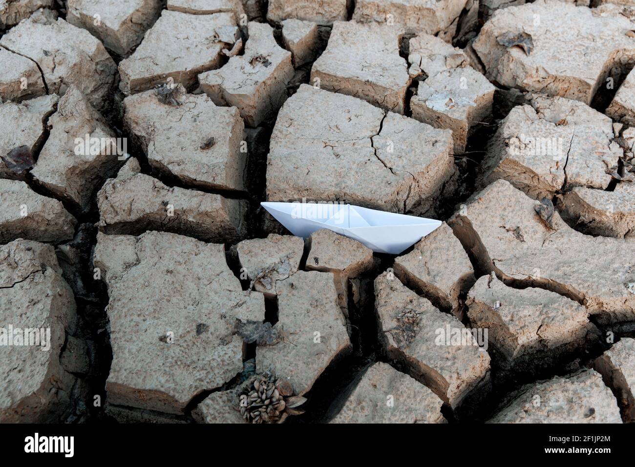 Paper boat on dry lake, conceptual drought, global warming Stock Photo ...