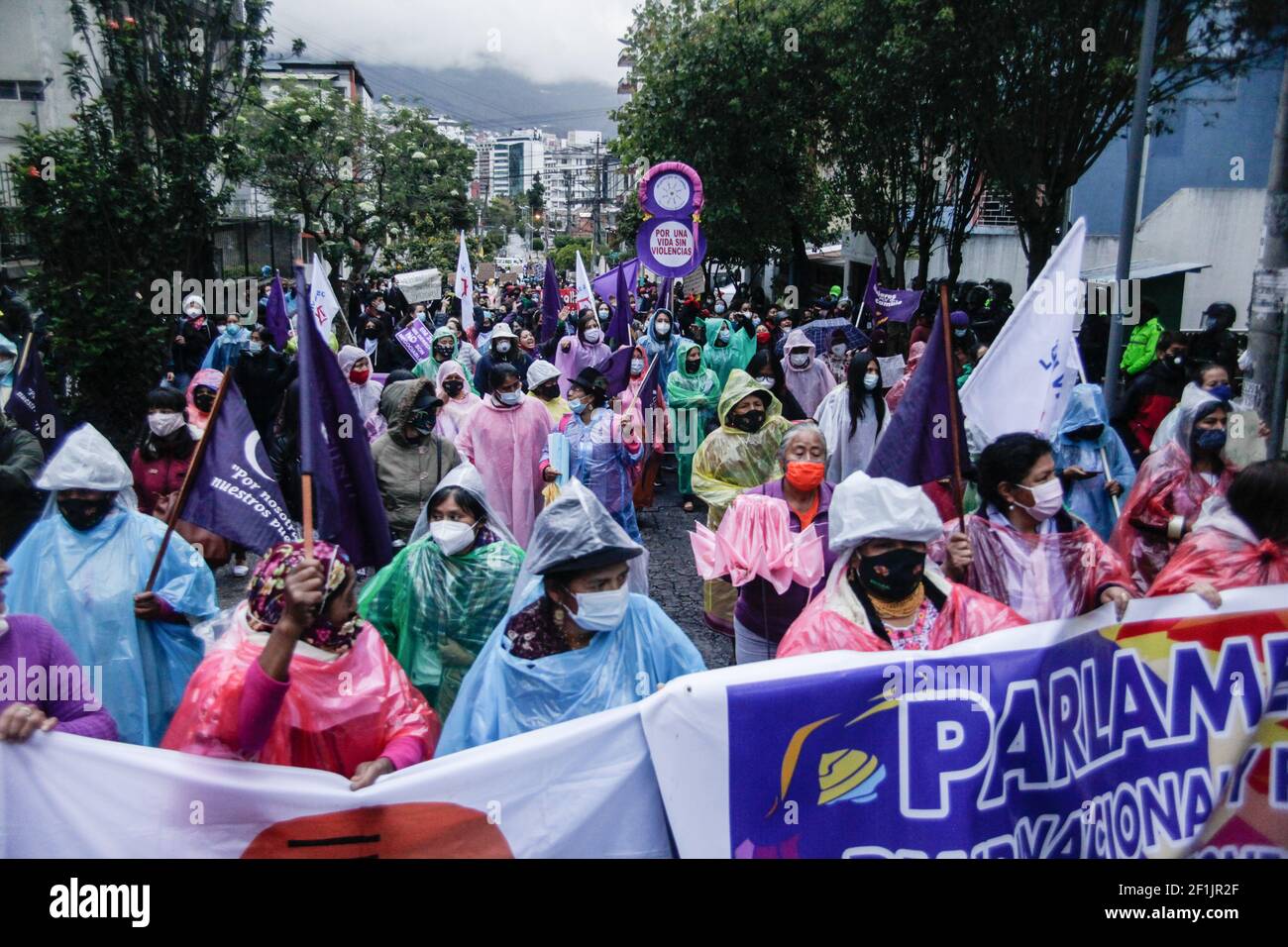 Protesters hold banners during the demonstration. In Quito, the capital ...