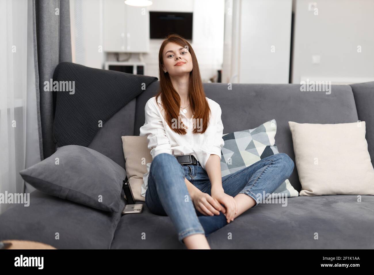 pretty woman sitting in comfortable sofa and resting interior Stock ...