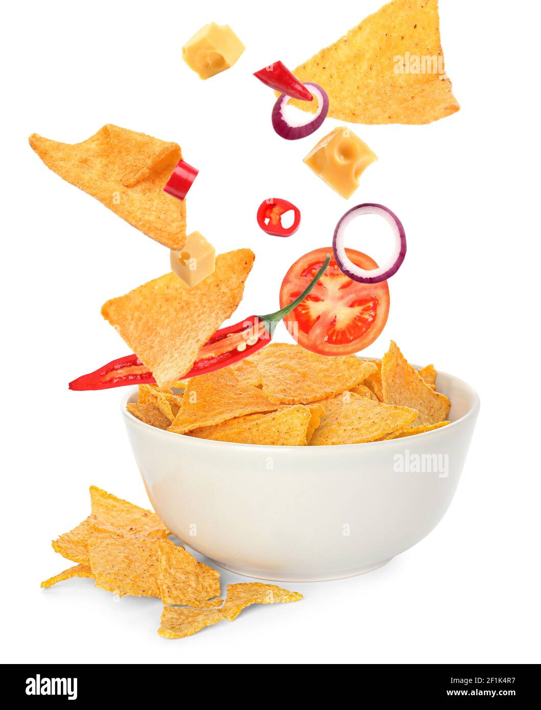 Flying nachos with ingredients and bowl on white background Stock Photo ...