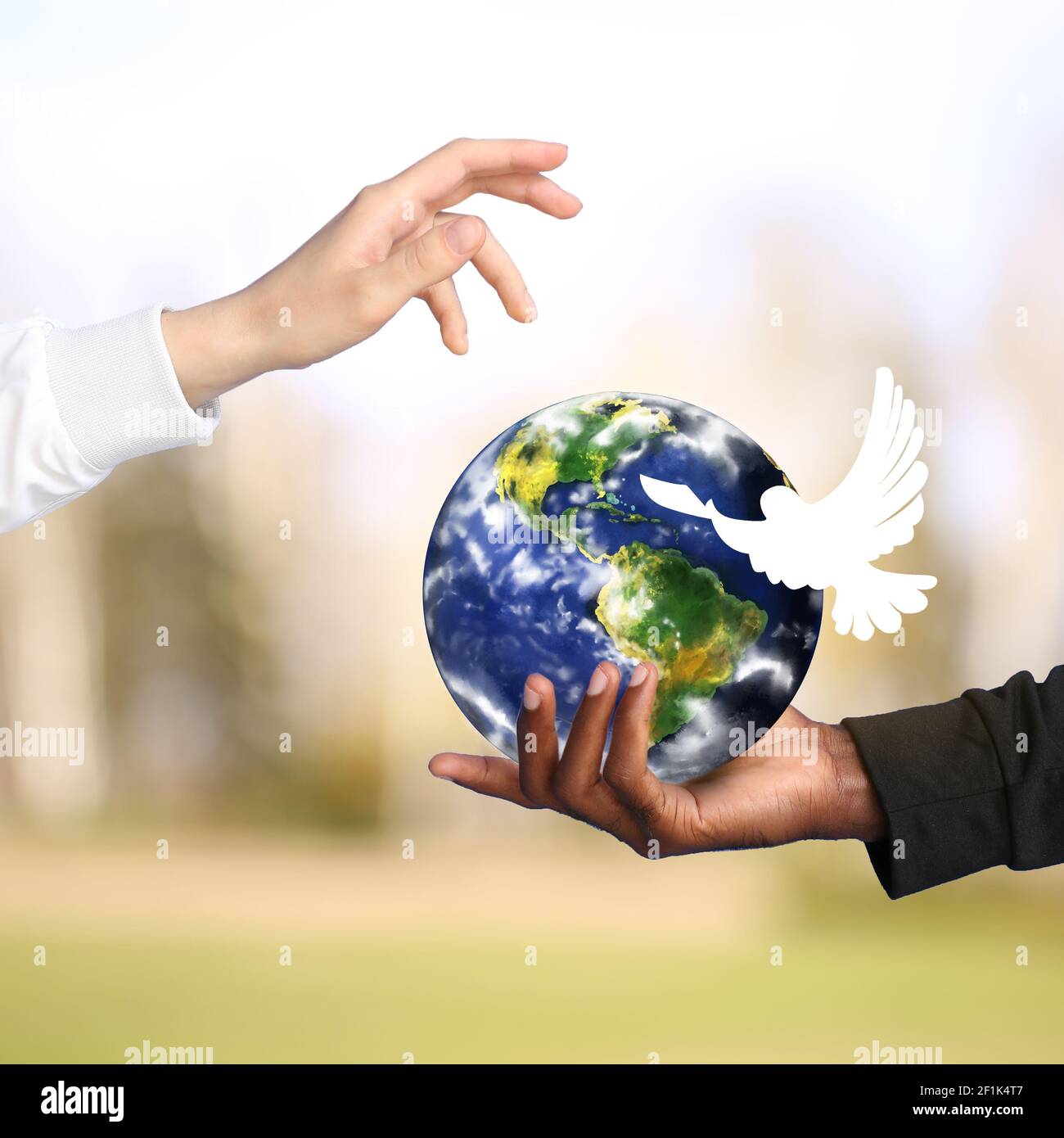 Hands of Caucasian woman and African-American man with model of Earth ...
