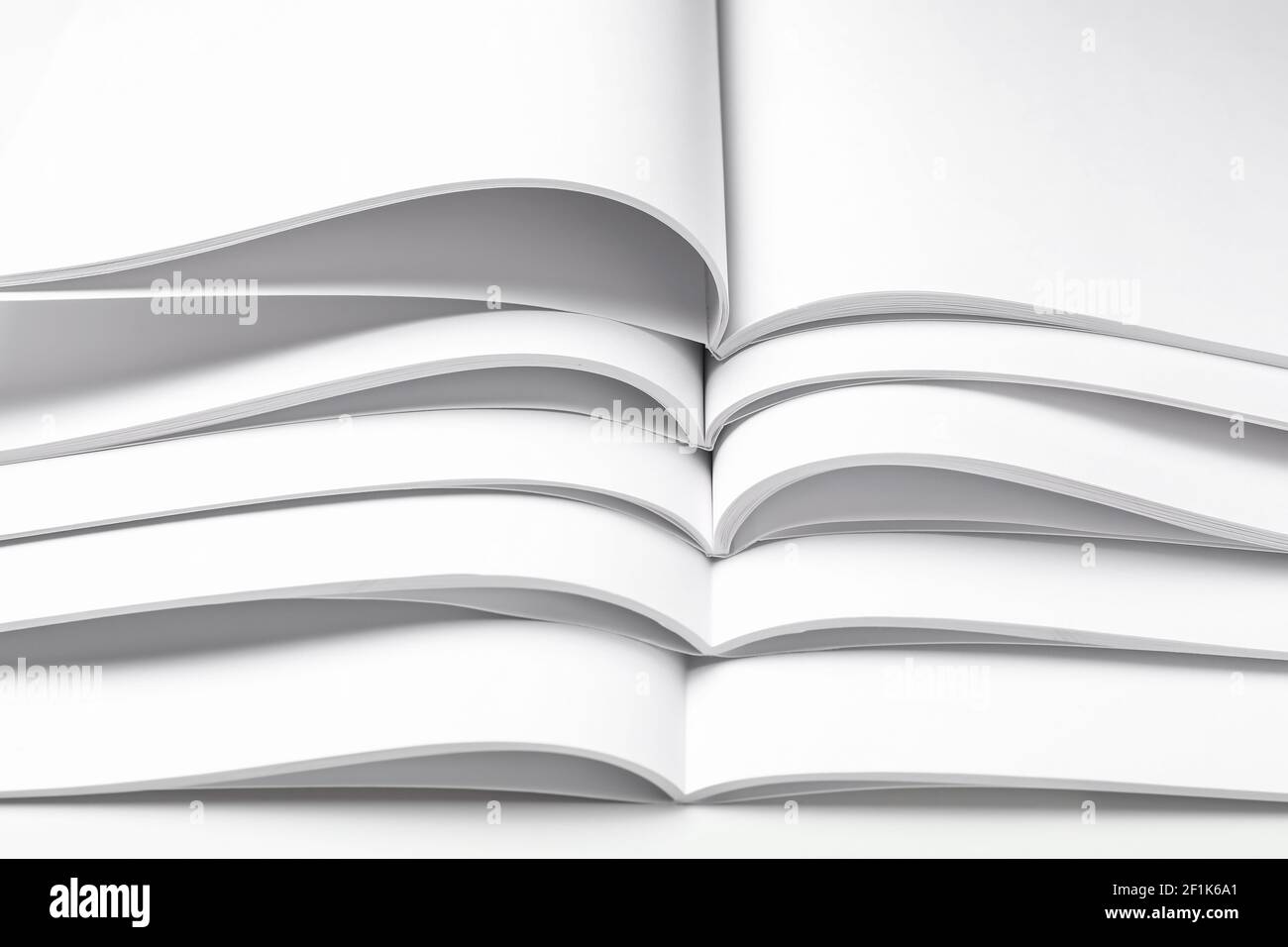 Open blank magazines on white background Stock Photo - Alamy