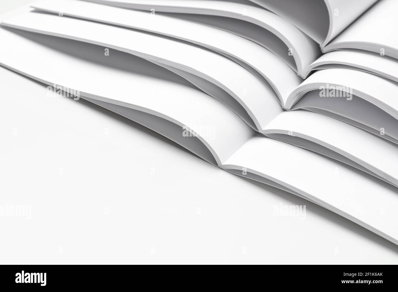 Open blank magazines on white background Stock Photo - Alamy