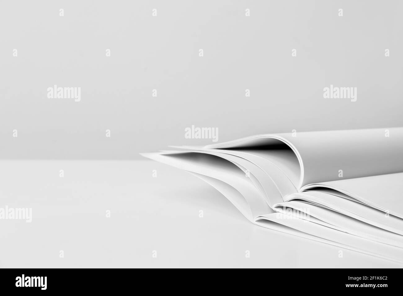 Open blank magazines on light background Stock Photo - Alamy