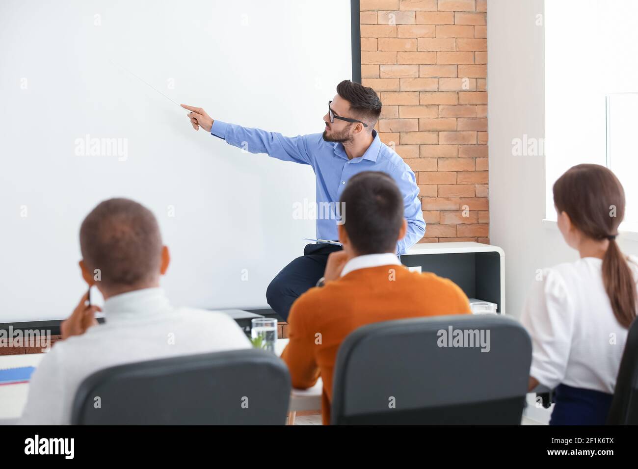 Businessman giving presentation during meeting in office Stock Photo ...