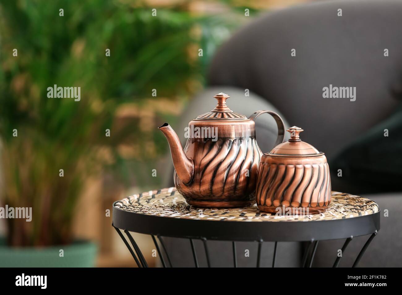 Stylish teapot and sugar bowl on table in room Stock Photo - Alamy