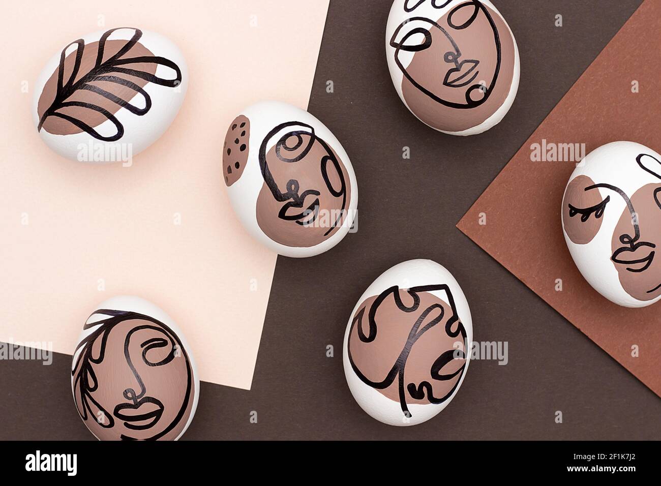 Happy Easter concept. Surreal faces on eggs on brown background. Art ...