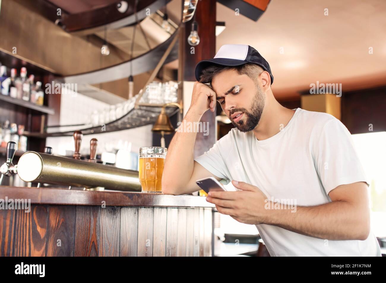 Sad young man after losing of his sports bet in pub Stock Photo - Alamy