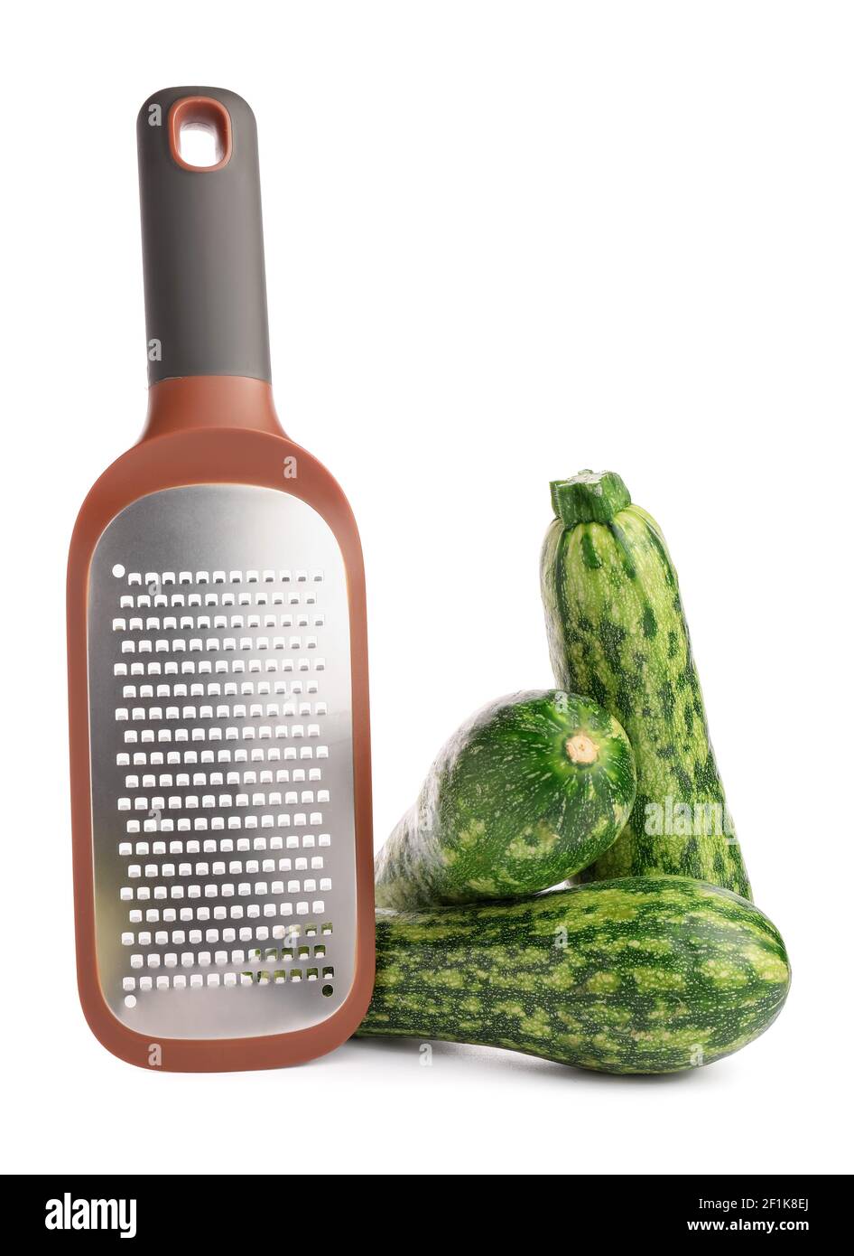 Metal grater and zucchini on white background Stock Photo - Alamy