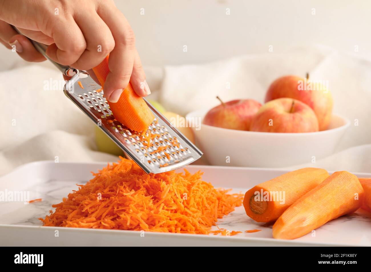Woman grating carrot delicious hi-res stock photography and images - Alamy