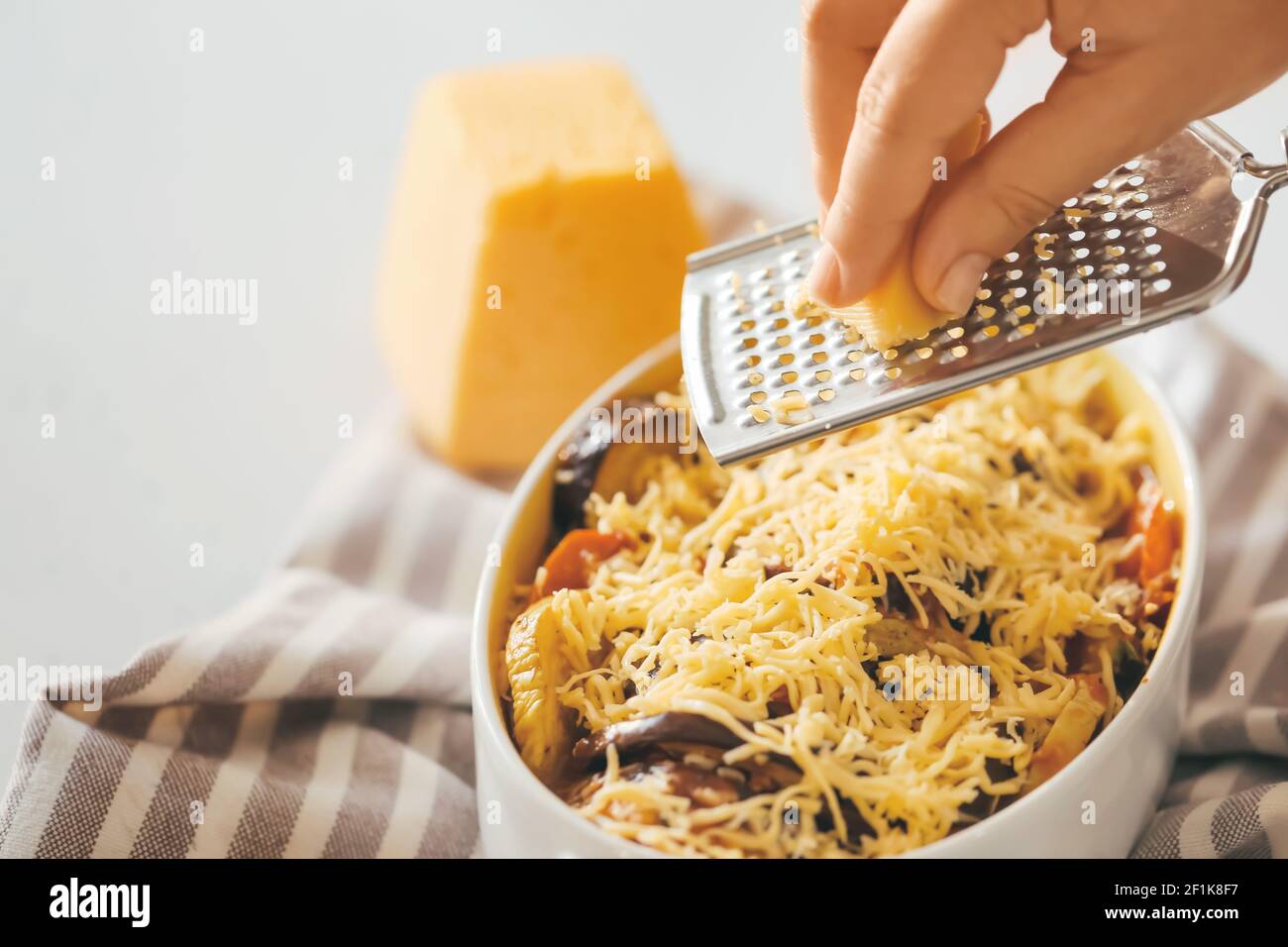 Woman grating cheese in kitchen, closeup Stock Photo - Alamy