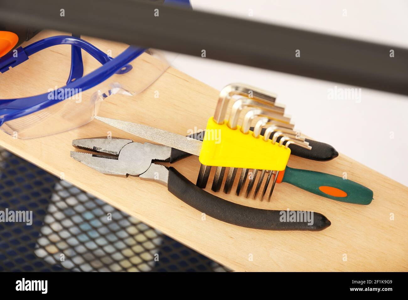 Different construction tools on rack in workshop, closeup Stock Photo ...