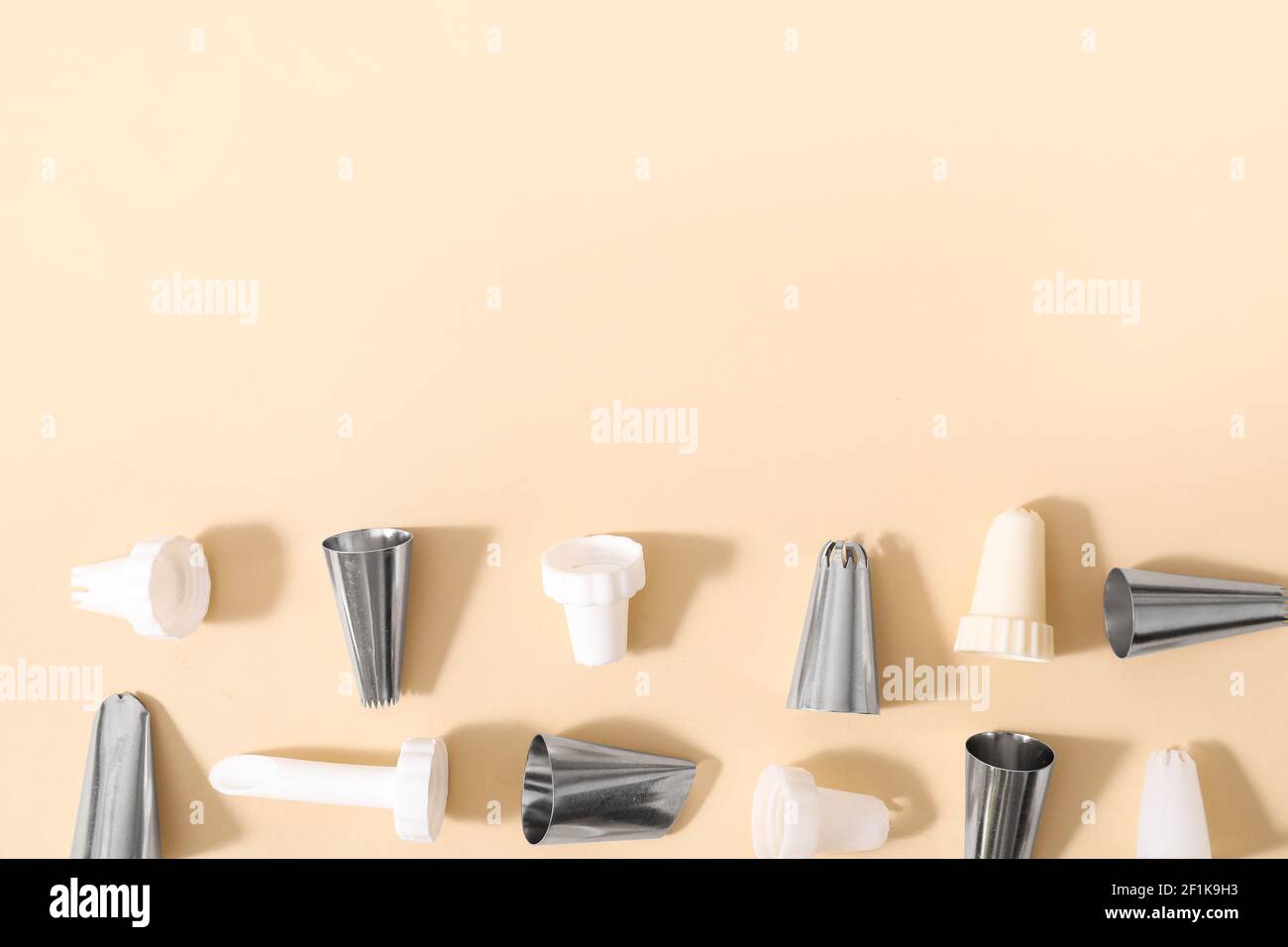 Different piping tips on color background Stock Photo - Alamy