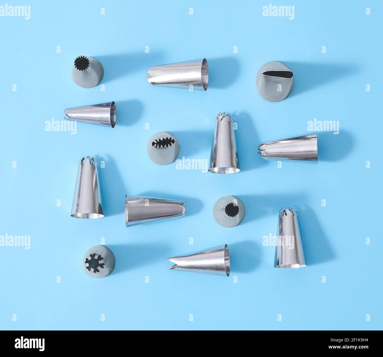 Different piping tips on color background Stock Photo - Alamy