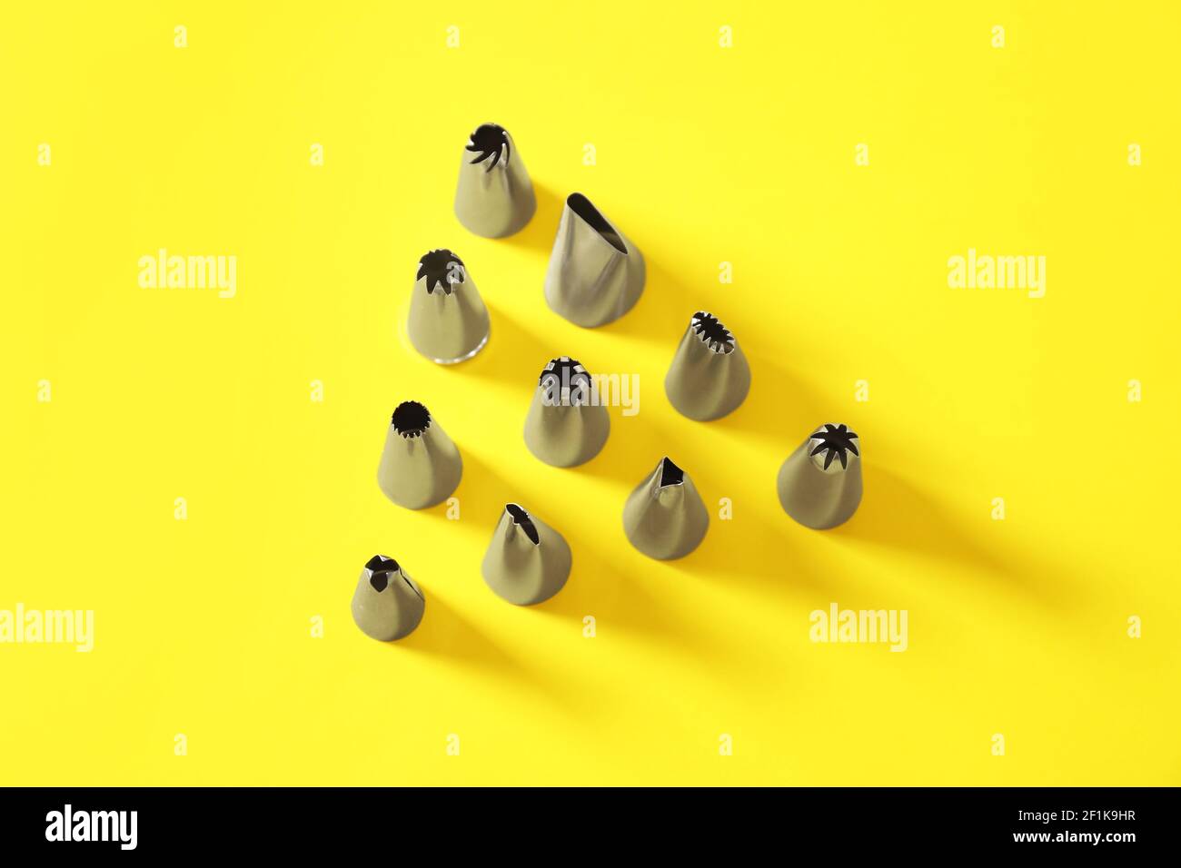 Different piping tips on color background Stock Photo - Alamy
