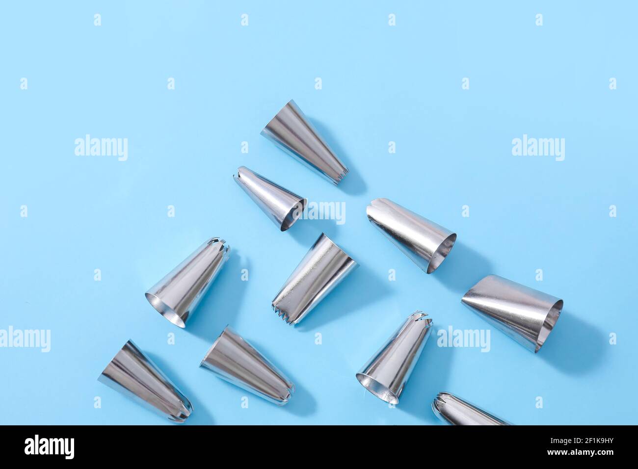 Different piping tips on color background Stock Photo - Alamy