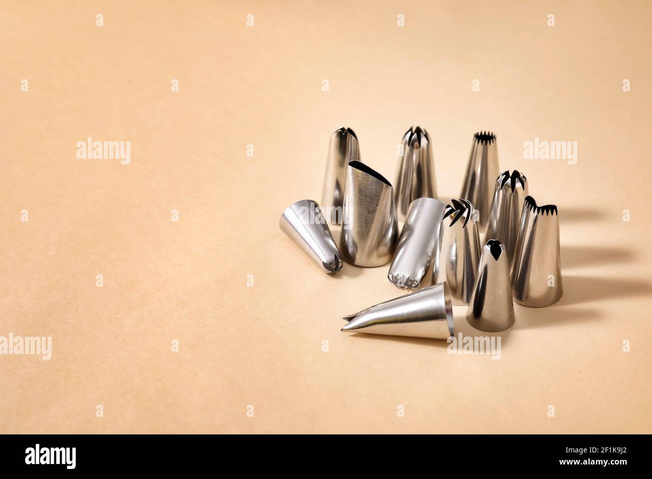 Different piping tips on color background, closeup Stock Photo - Alamy