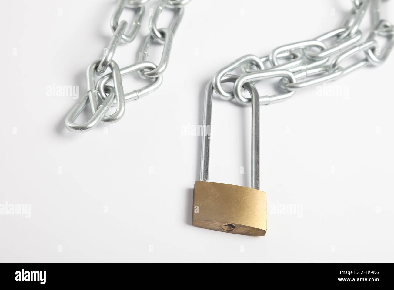 Padlock and chains, on white background Stock Photo - Alamy