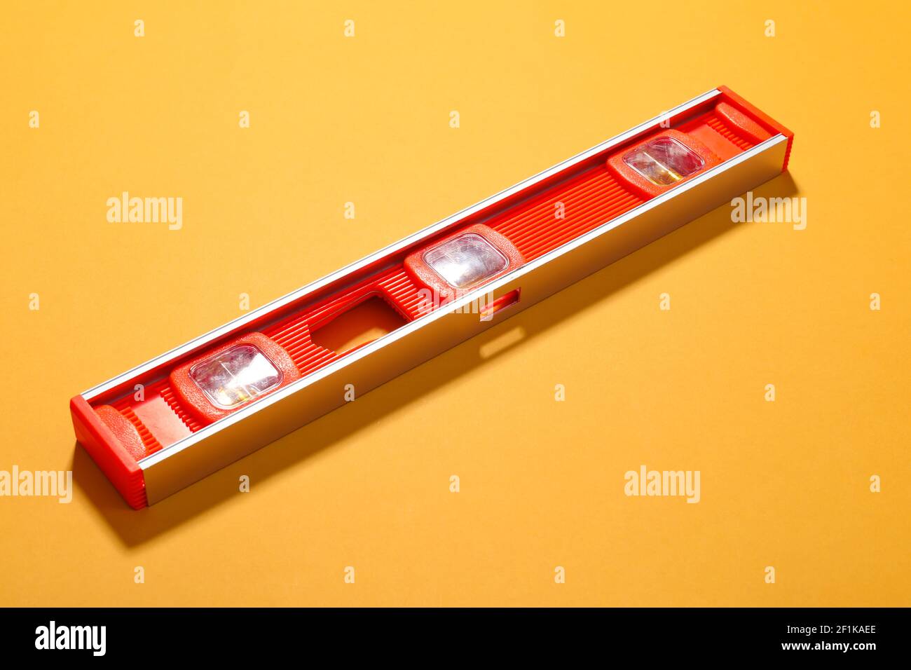 Spirit level on color background Stock Photo - Alamy