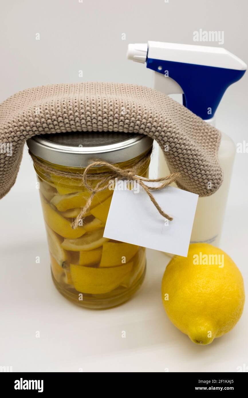 homemade lemon cleaner with spray bottle, cleaning cloth and an ...