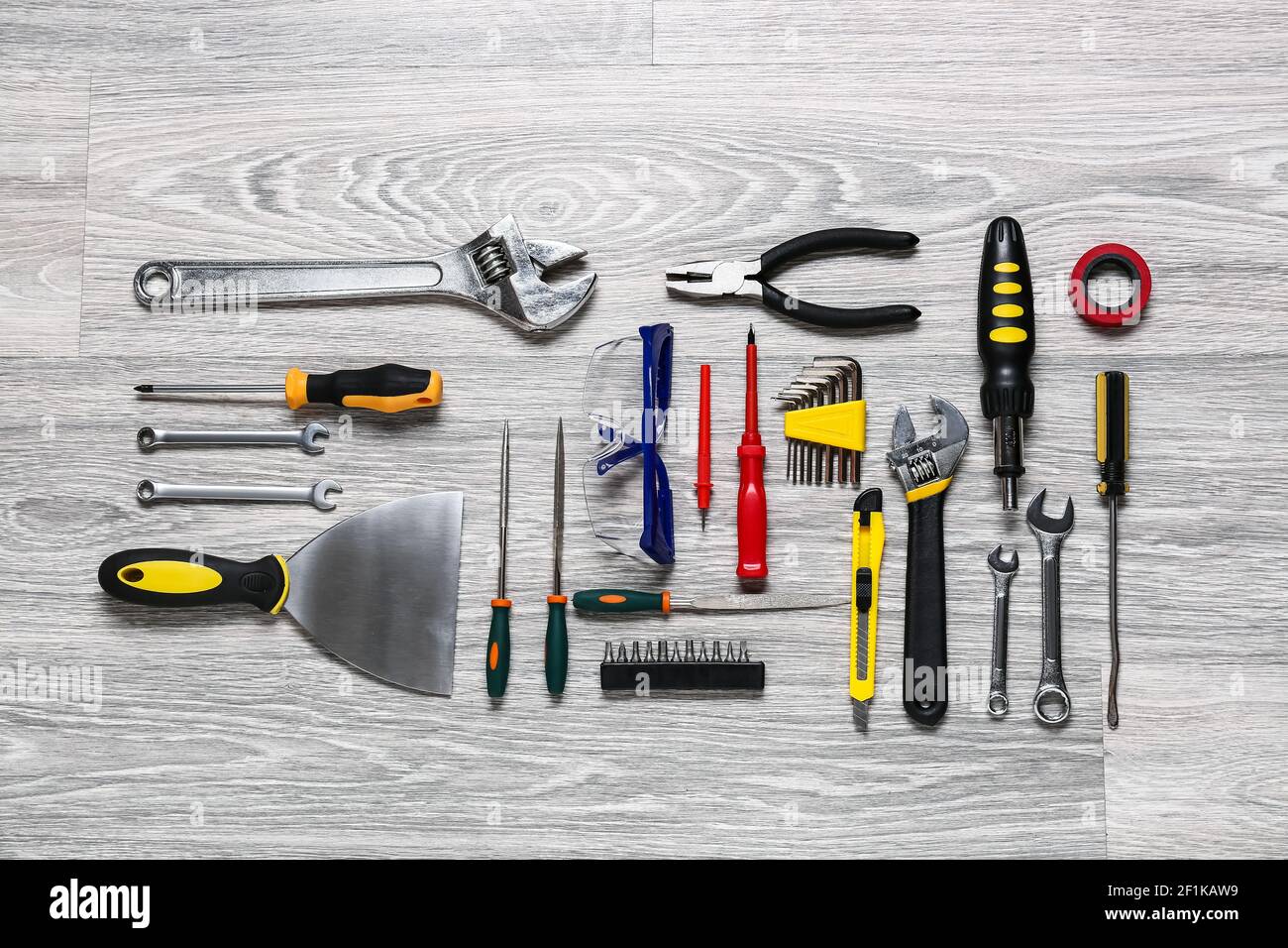 Set of construction tools on light wooden background Stock Photo - Alamy