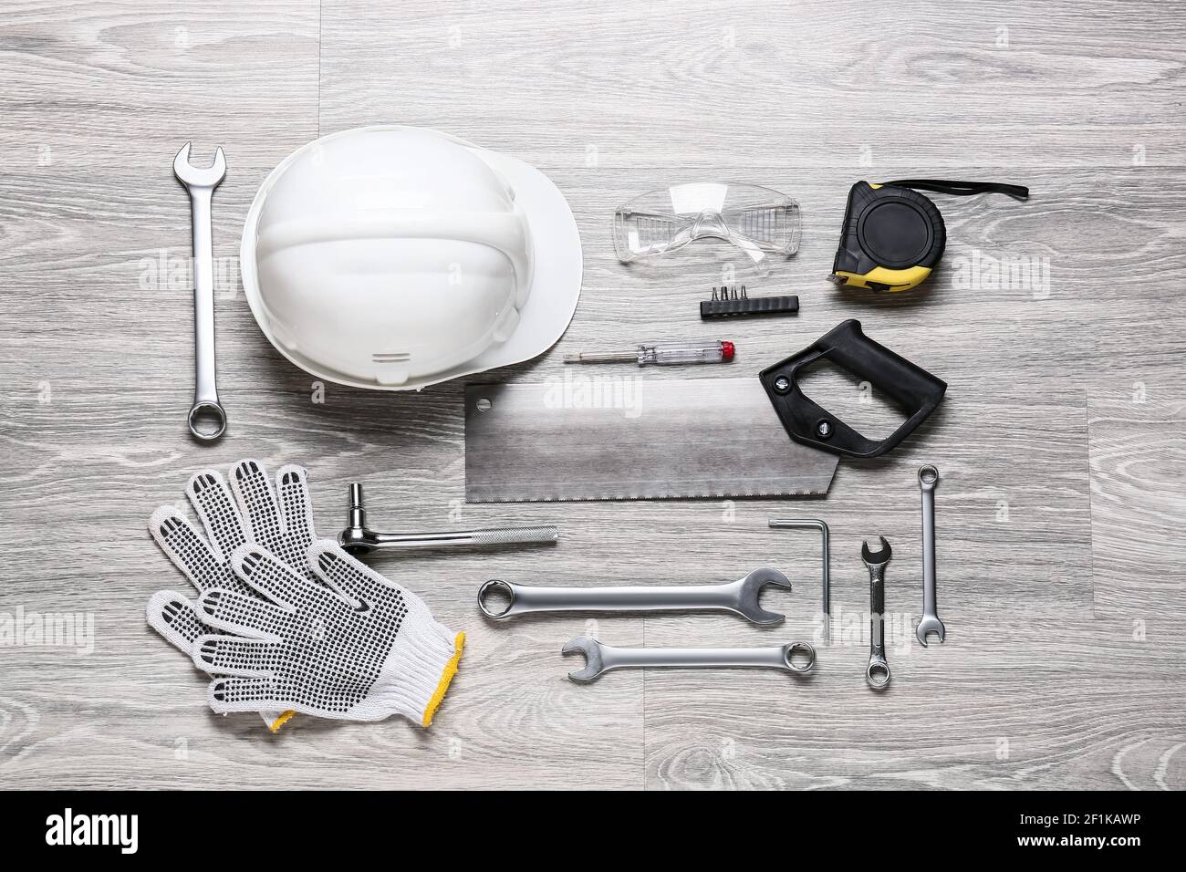 Set of construction tools on light wooden background Stock Photo - Alamy