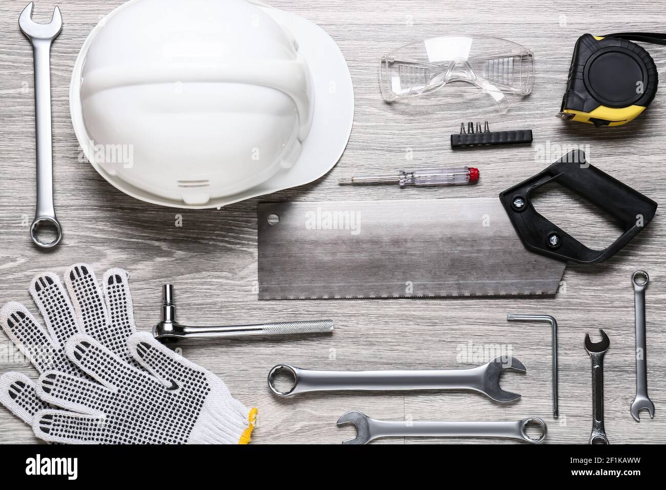 Set of construction tools on light wooden background Stock Photo - Alamy