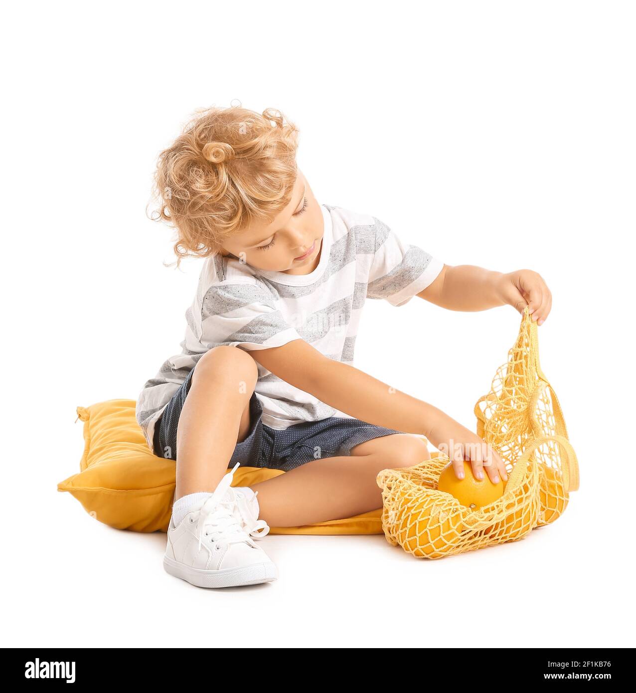 Cute little boy and bag with oranges on white background Stock Photo ...